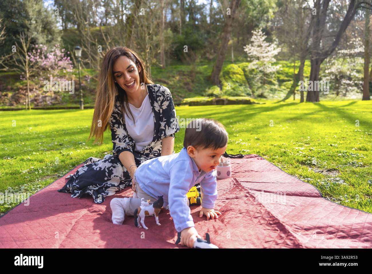 Mother and baby enjoying quality time together, playing with animal ...