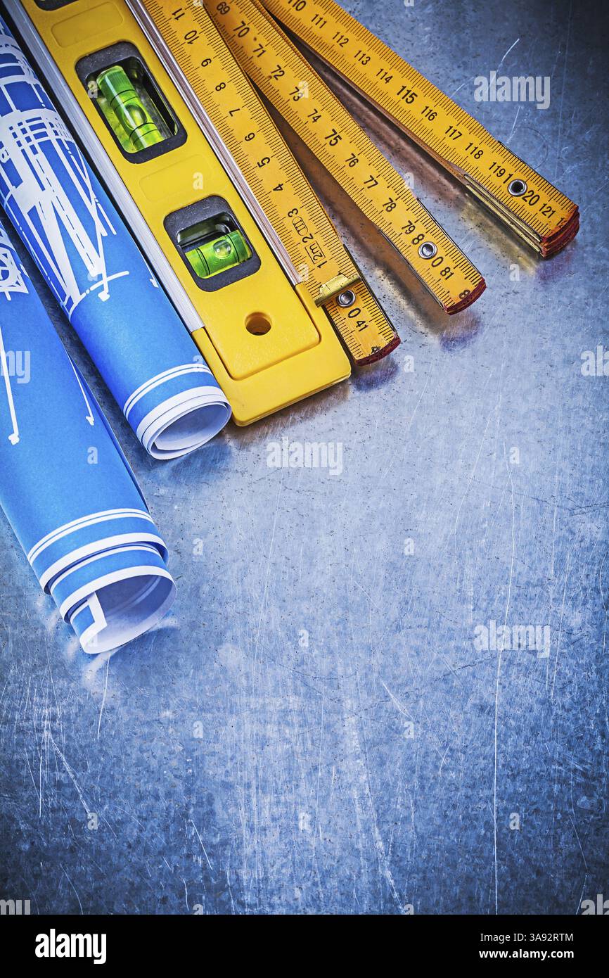 Wooden meter blue construction plans level on metallic background Stock ...