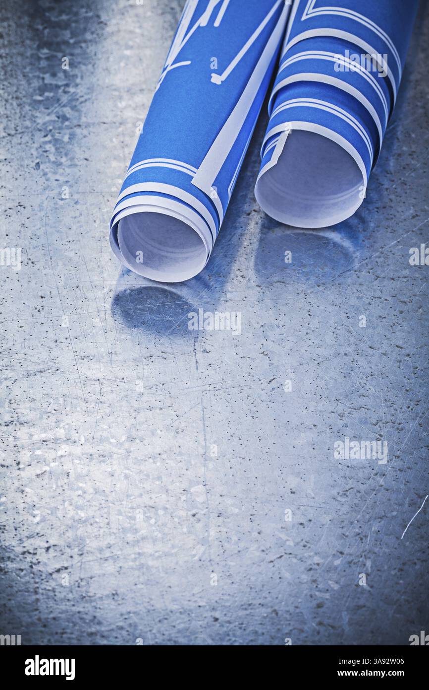 Heap of blue engineering drawings on metallic background building ...