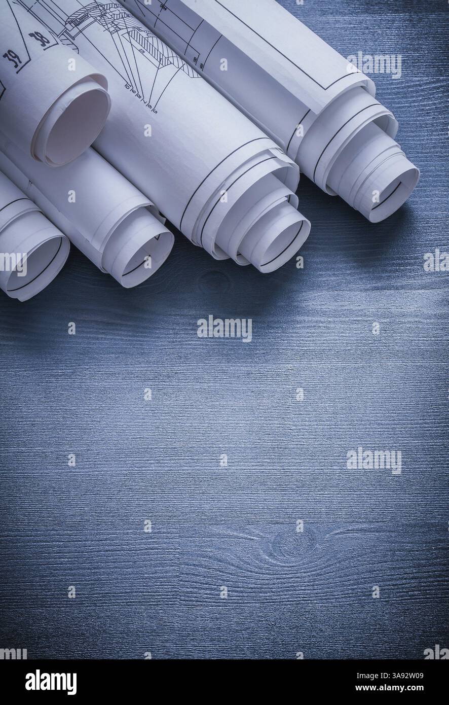 Vertical view stack of rolled blueprints on board Stock Photo - Alamy