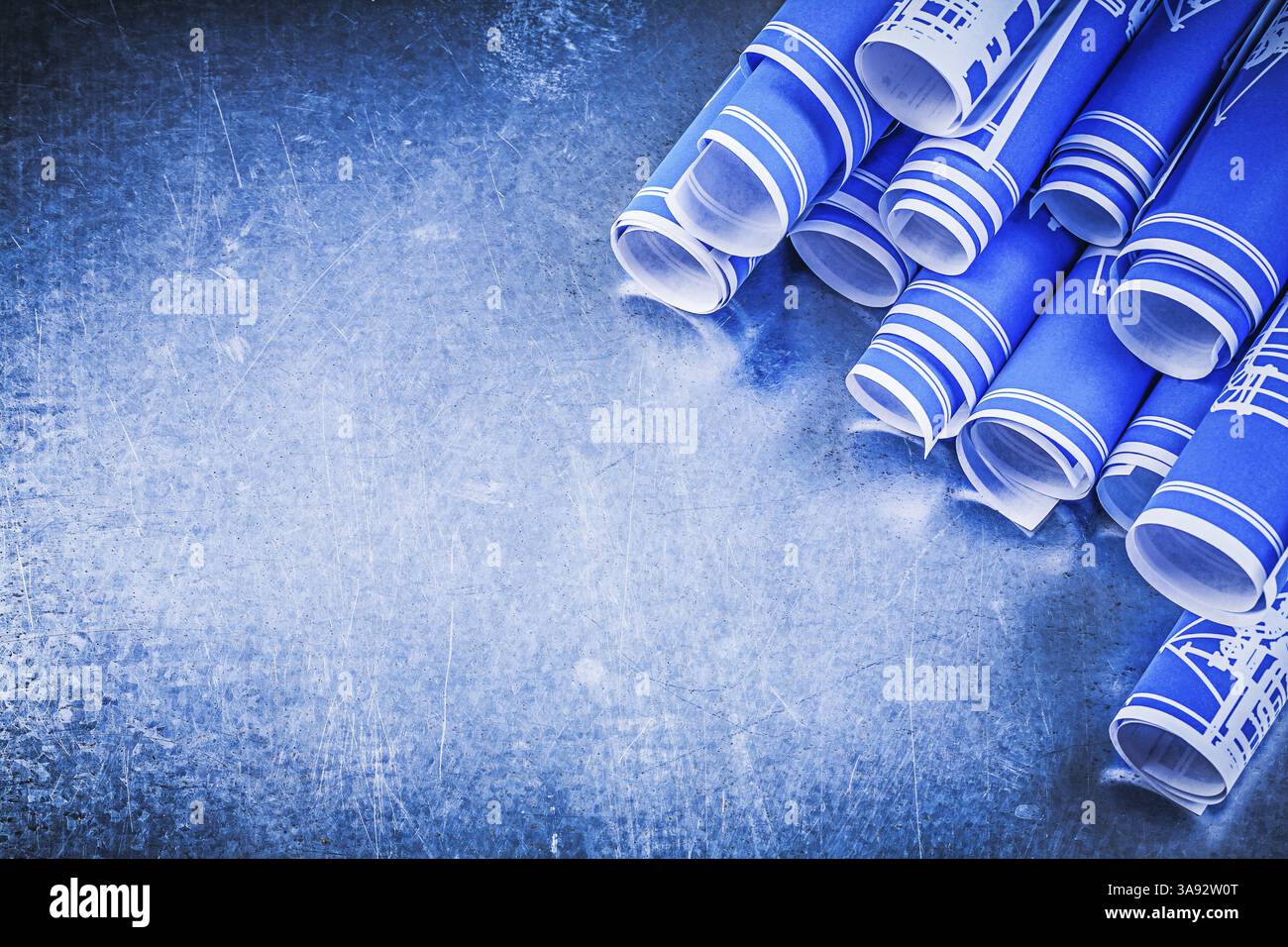 Heap of blue engineering drawings on metallic background construction ...