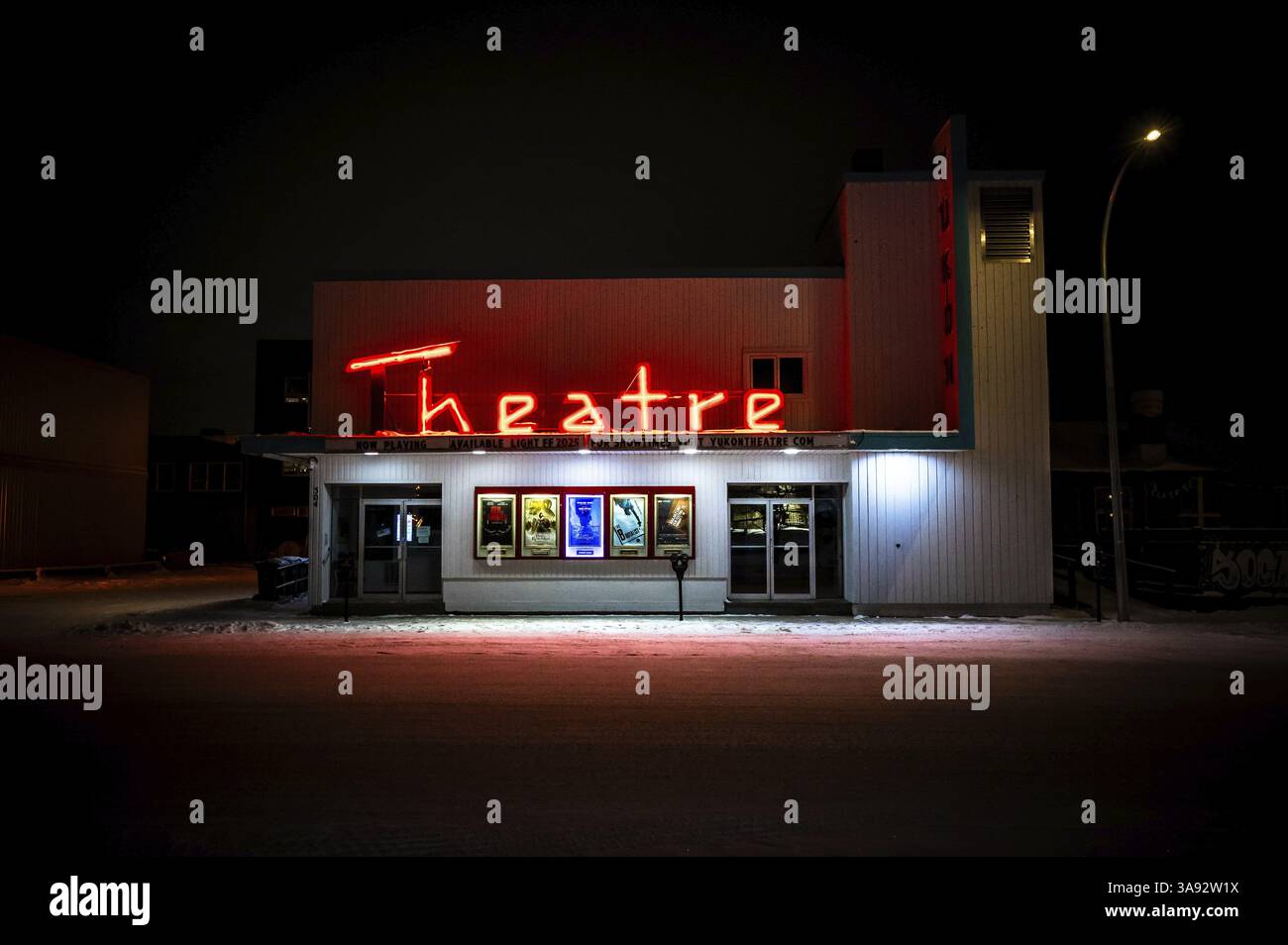 Illuminated theatre at night with red lettering, Yukon, Canada ...