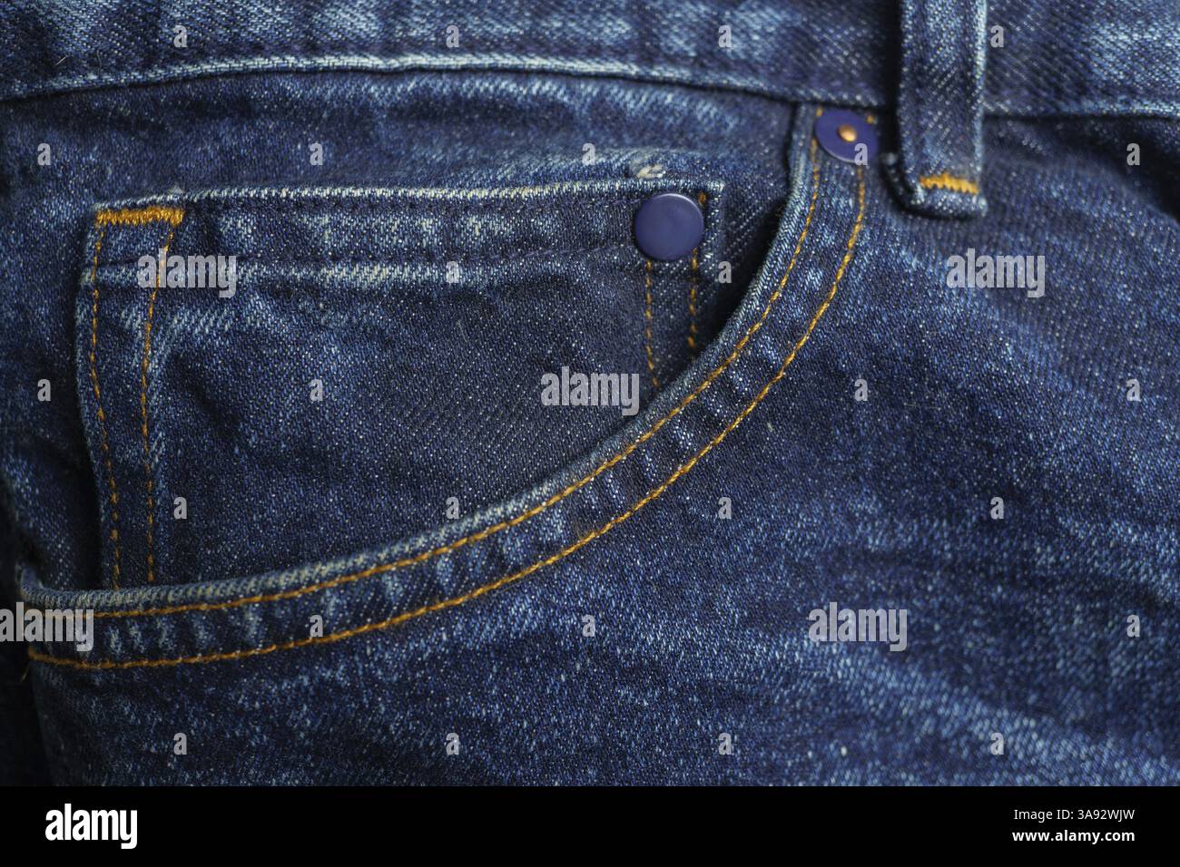 Close-up of blue denim jacket pocket with orange stitching Stock Photo ...