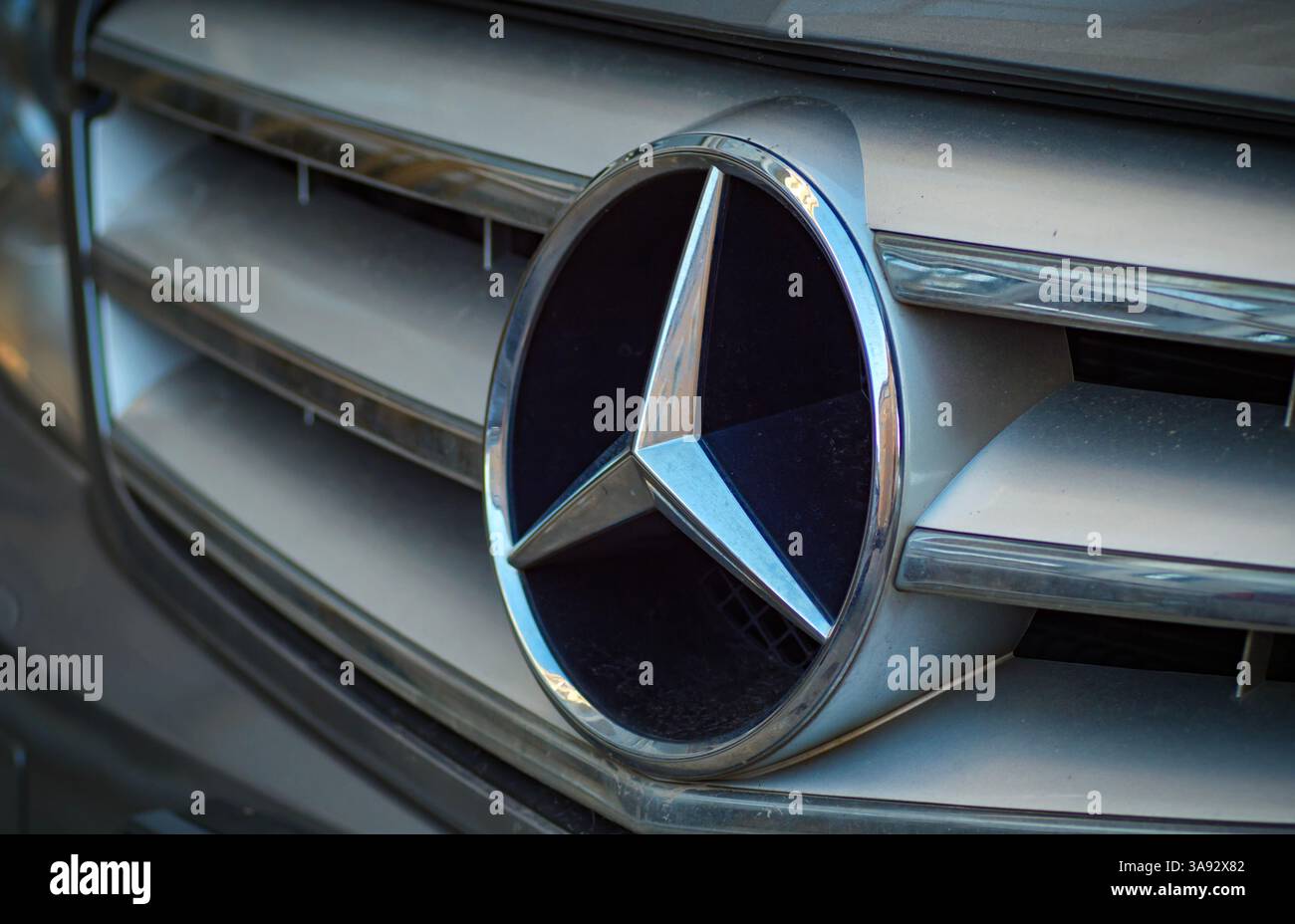 A close-up shot of the front logo on the Mercedes C180 W204, showcasing the iconic Mercedes-Benz ...