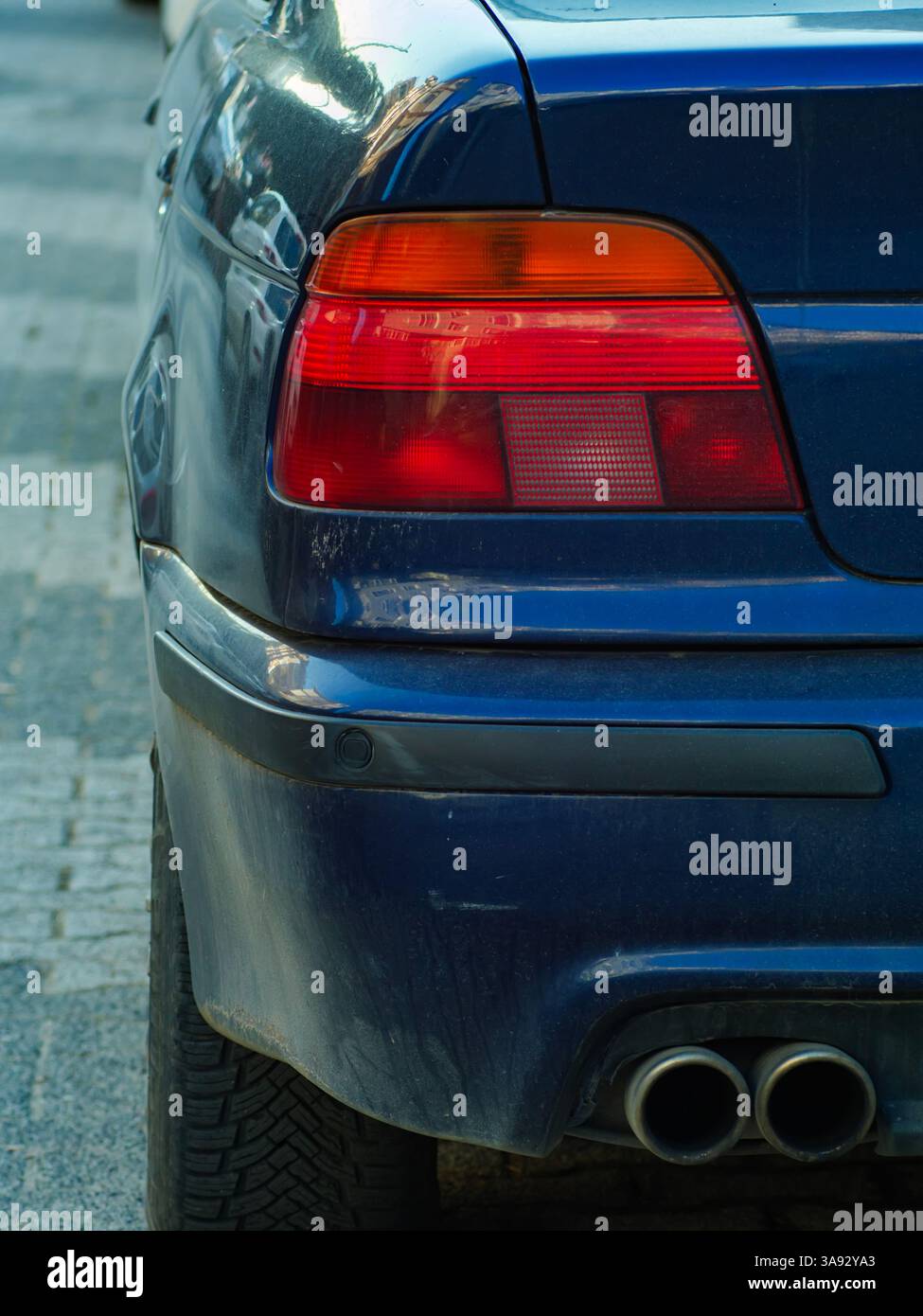 A detailed photograph of the rear light and exhaust system on a BMW E39 ...