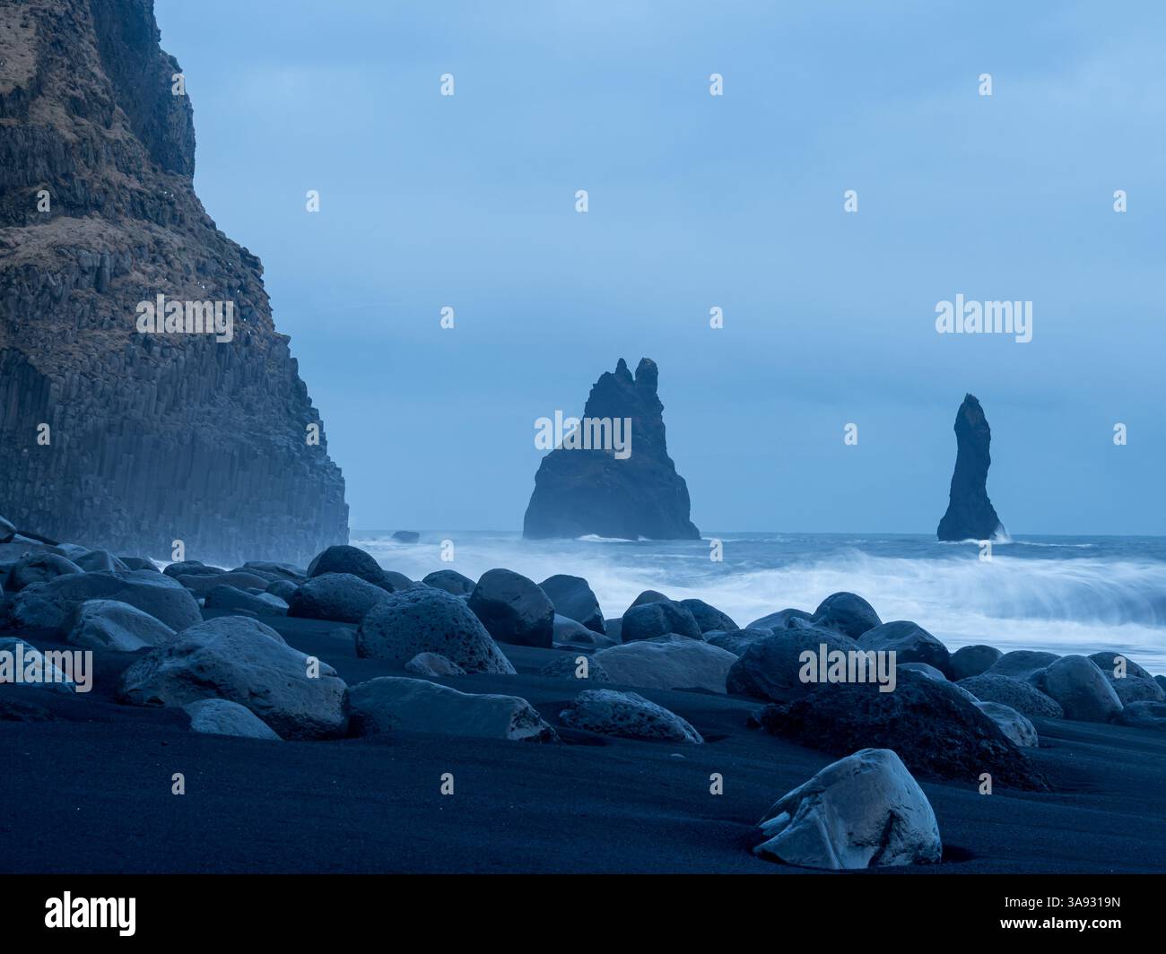 Reynisfjara Beach with dramatic basalt columns and Reynisdrangar sea ...