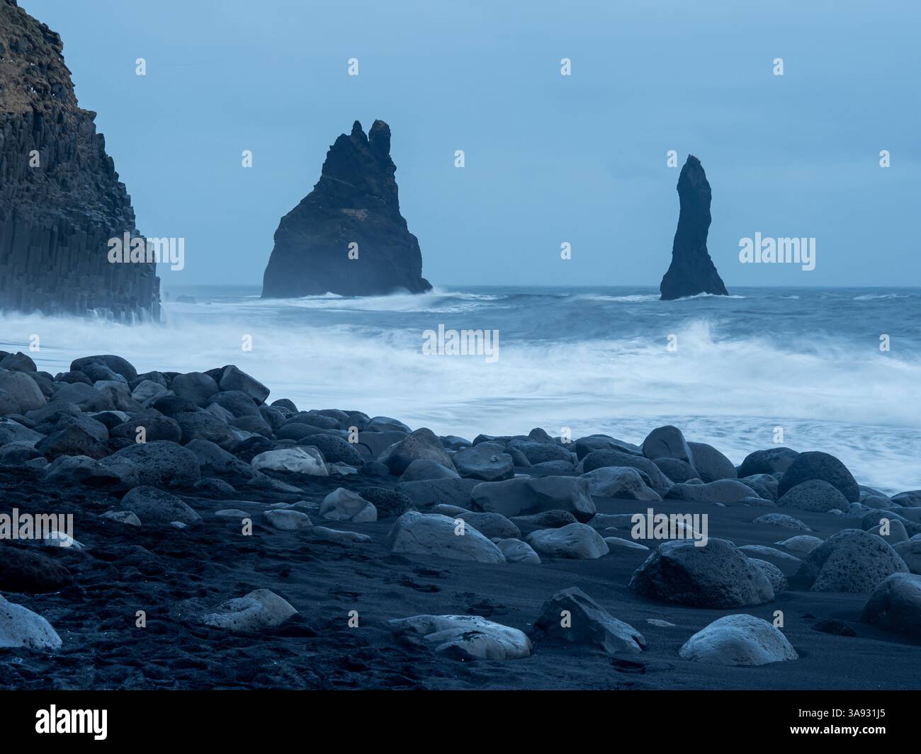 Reynisfjara Beach at twilight with the iconic Reynisdrangar sea stacks ...