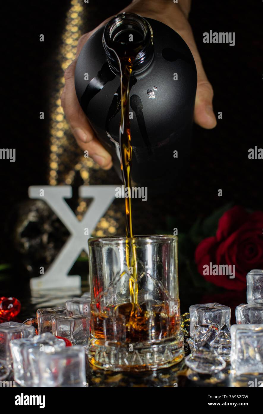Closeup Barman pouring whiskey into glass Stock Photo - Alamy