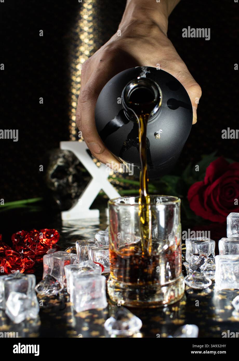 Closeup Barman pouring whiskey into glass Stock Photo - Alamy