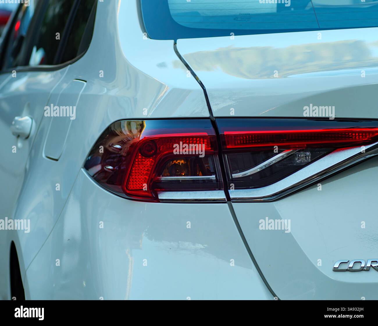 A detailed shot of the rear light of a white Toyota Corolla, showcasing ...