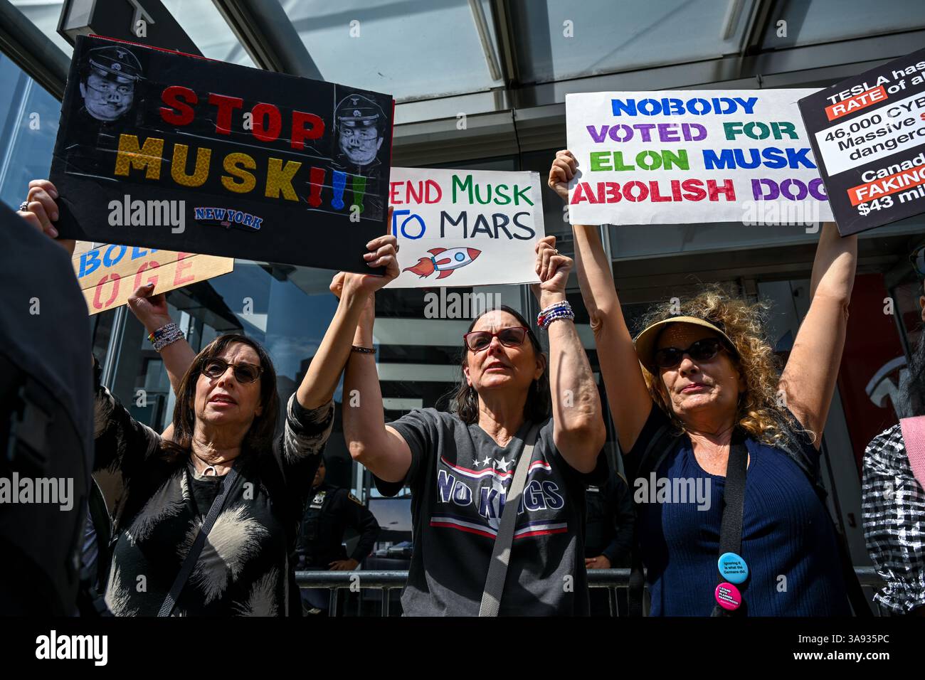 People attend a 'Tesla Takedown NYC' protest outside the Tesla Showroom ...