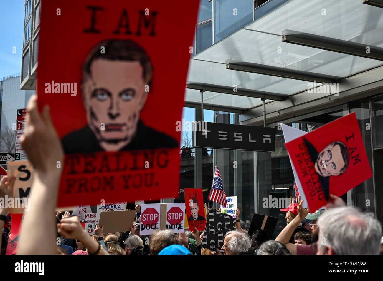 People attend a 'Tesla Takedown NYC' protest outside the Tesla Showroom ...