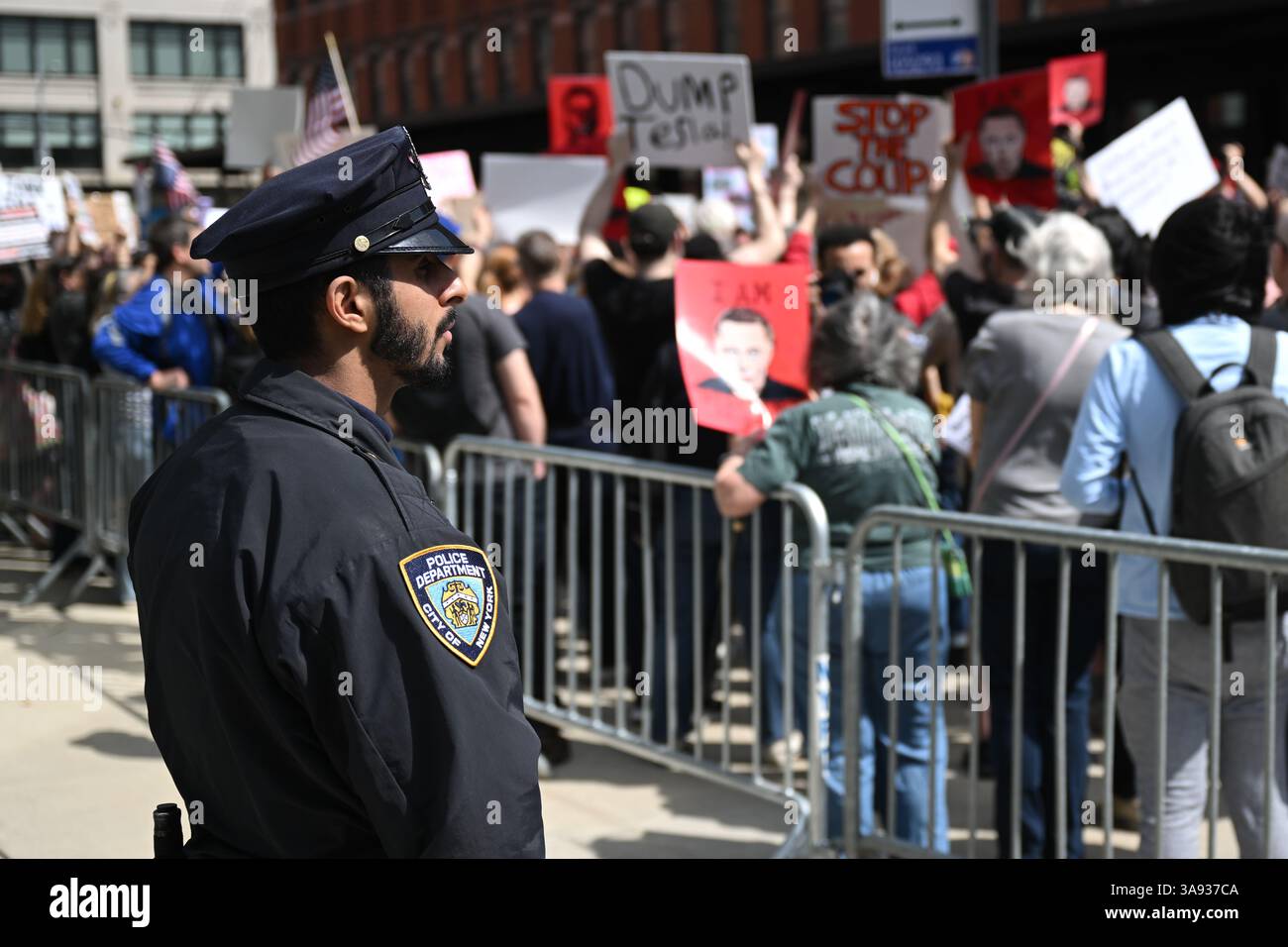Police officers stand guard outside the Tesla Showroom in the ...