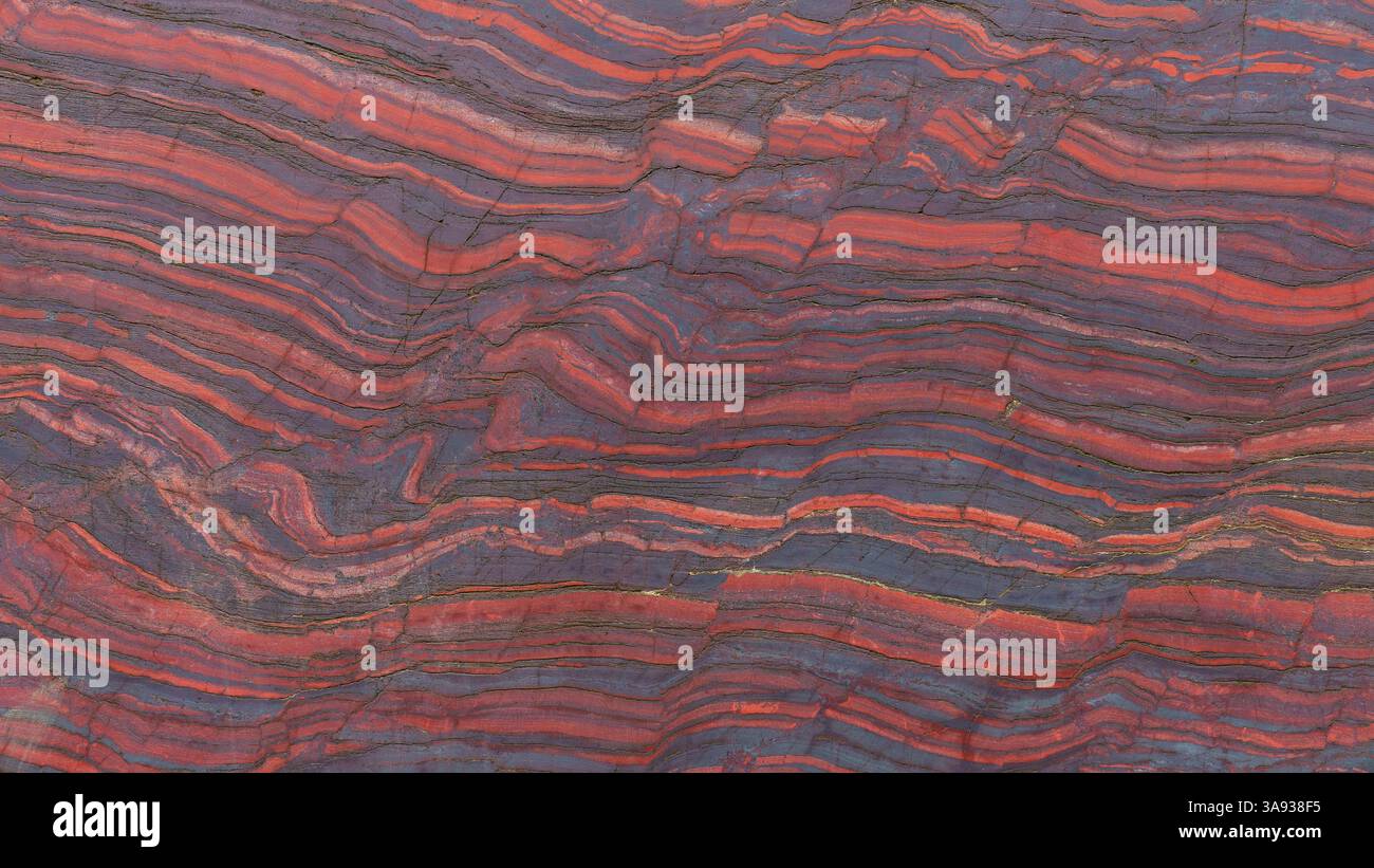 Close up cut red stone with natural patterns and texture. Banded iron ...