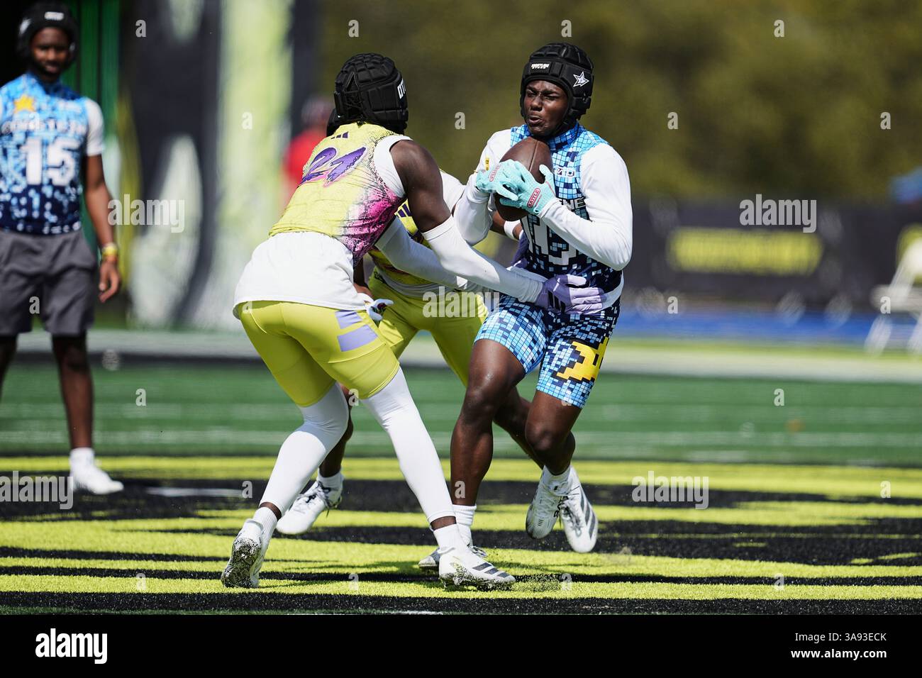 Coastline Stars wide receiver Greg Wilfred, right, is tagged by Midwest Boom safety Devon ...