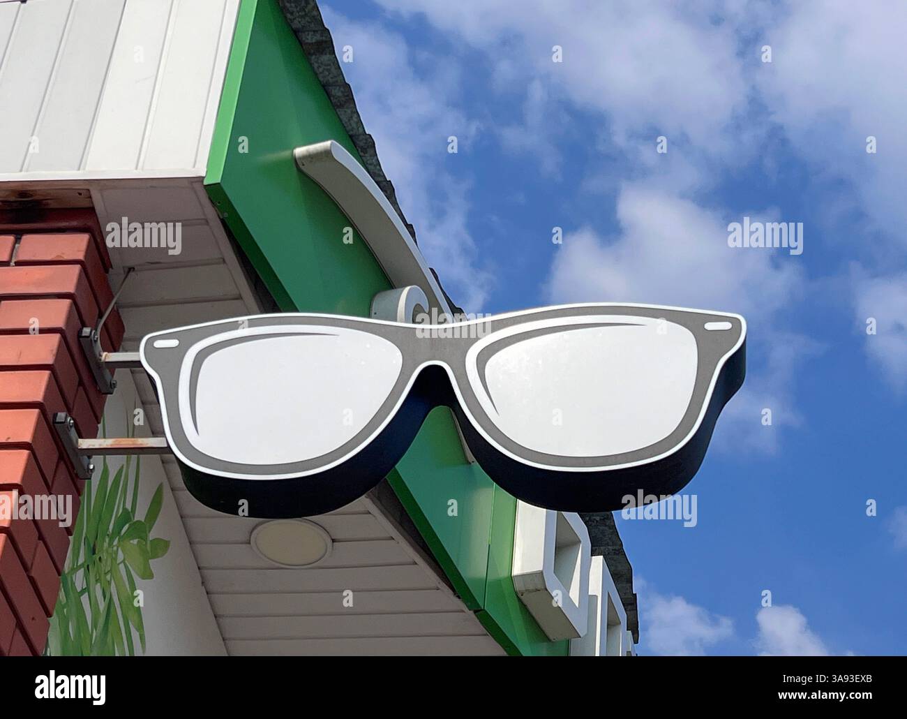Glasses sign at the entrance to optical store Stock Photo - Alamy