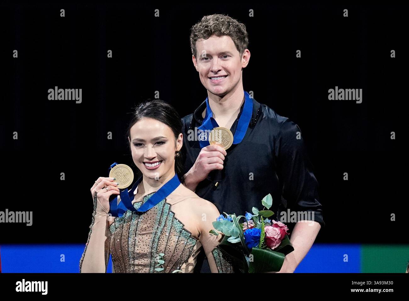 Gold medalists Madison Chock and Evan Bates, of the United States, hold ...