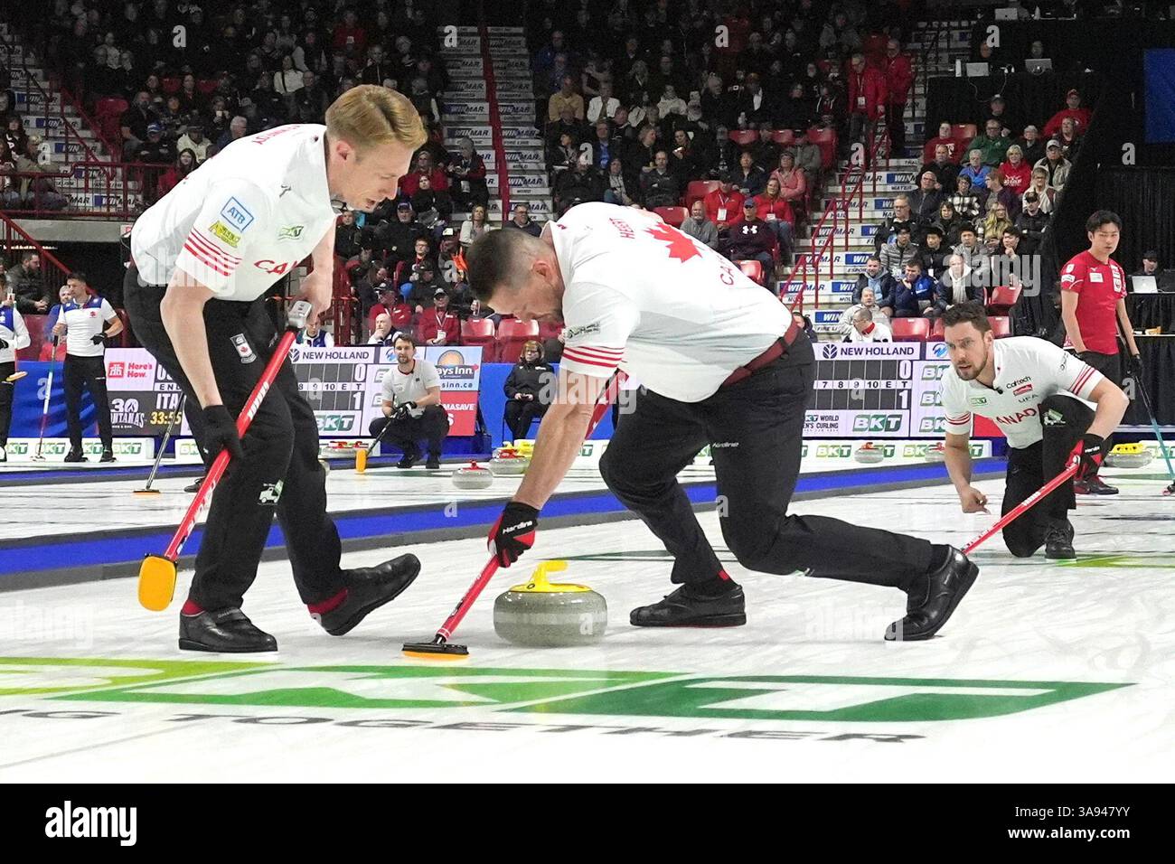 Canada's Marc Kennedy, left, and Ben Herbert sweep for Brett Gallant ...