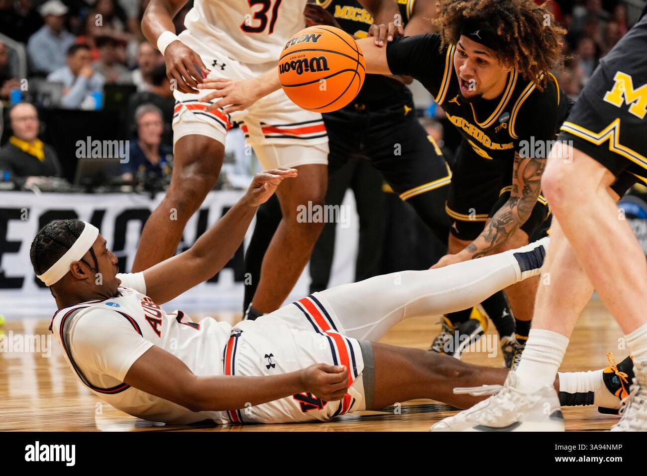 Michigan guard Tre Donaldson, right, and Auburn guard Denver Jones ...
