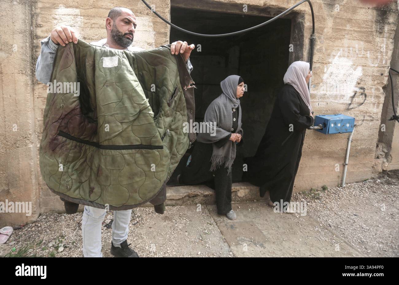 The brother of Palestinian Ahmed Bani Odeh holds his blood-stained ...
