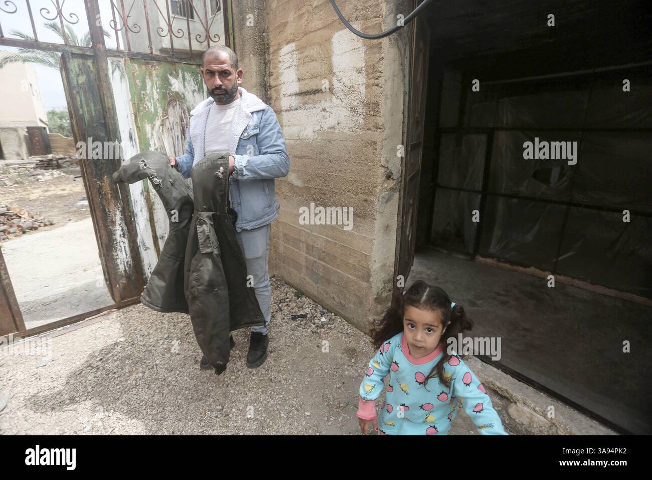 The brother of Palestinian Ahmed Bani Odeh holds his blood-stained ...