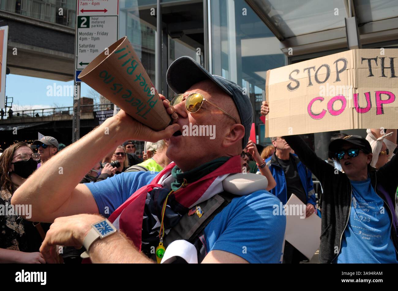 An anti-Elon Musk demonstrator chants slogans outside a Tesla showroom ...