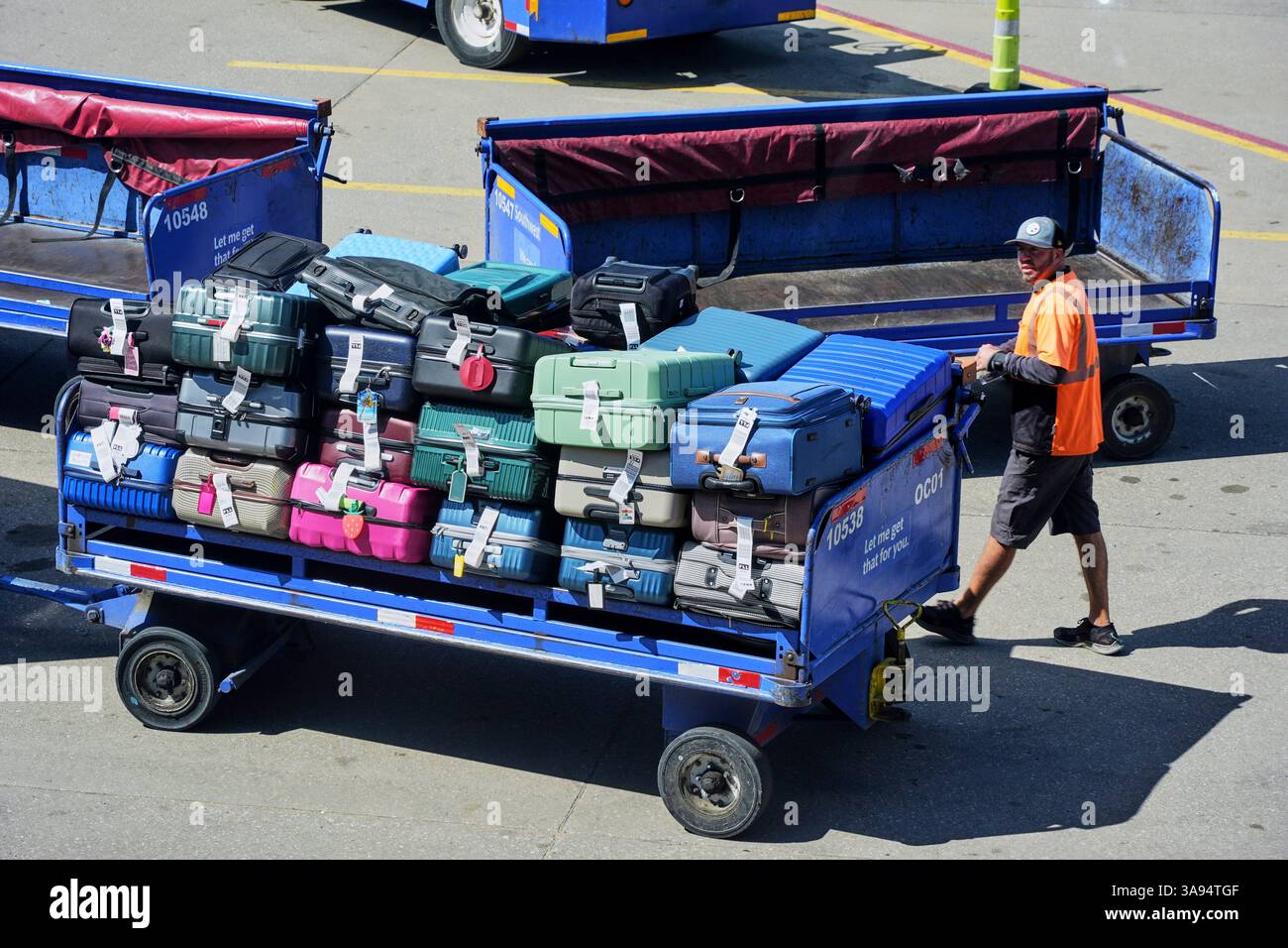 A Southwest Airlines baggage cart sits on the tarmac before being ...