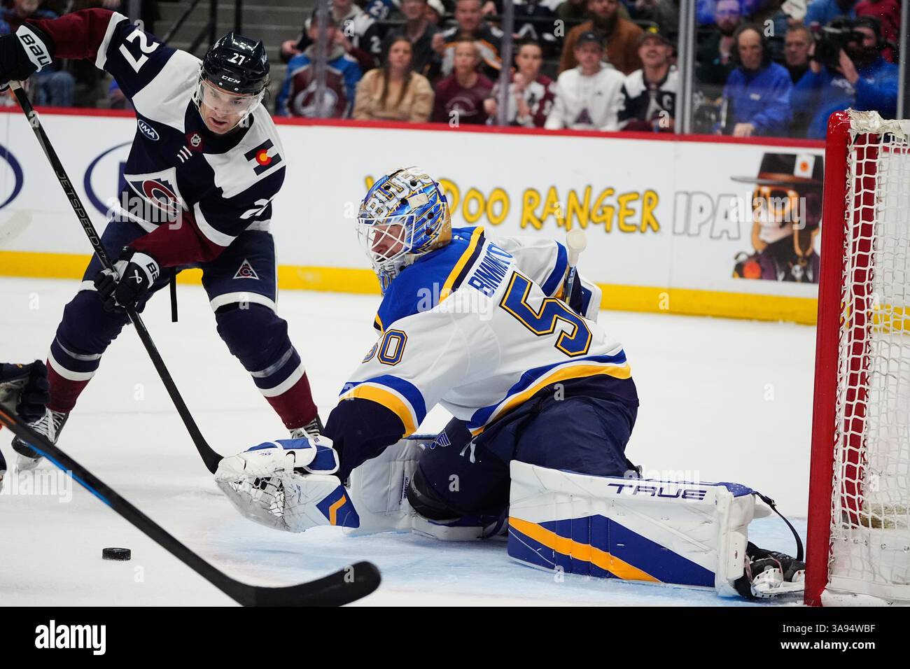 St. Louis Blues goaltender Jordan Binnington, right, stops a shot off ...