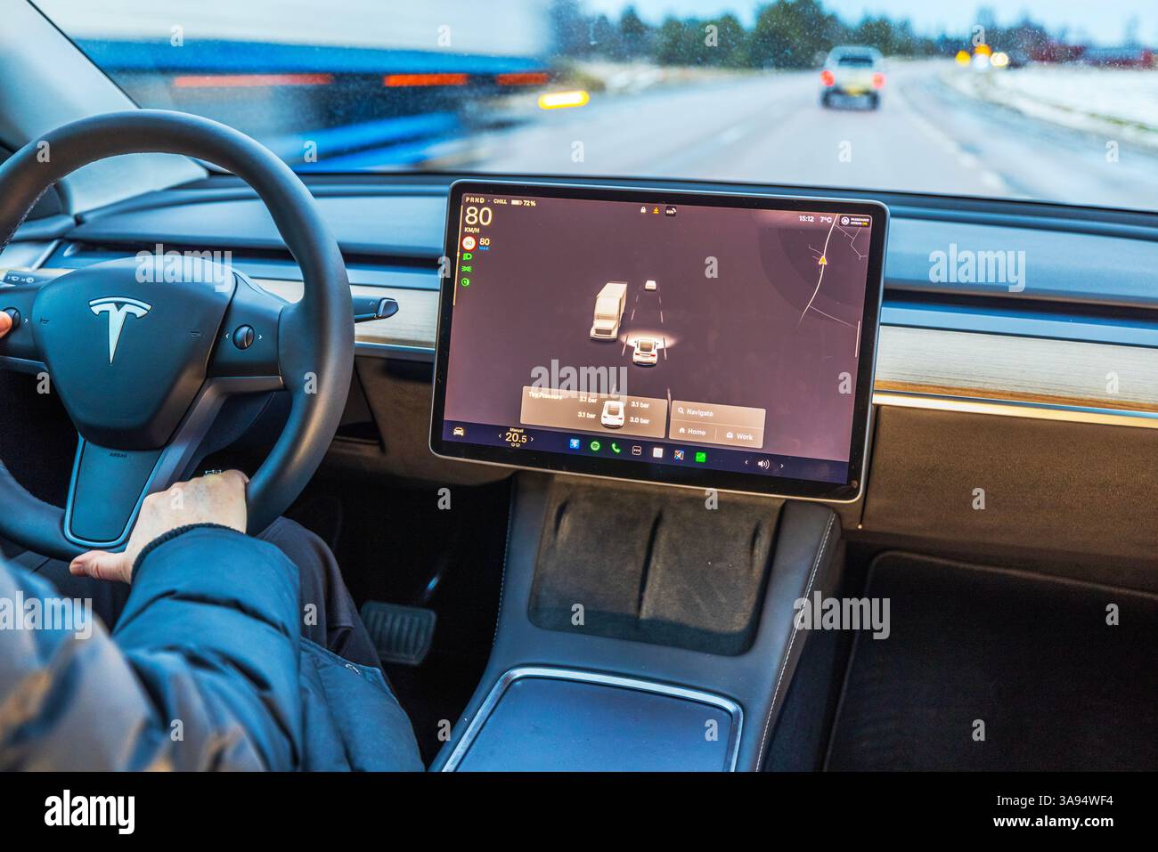 Interior of Tesla Model Y with autopilot screen showing vehicle driving ...