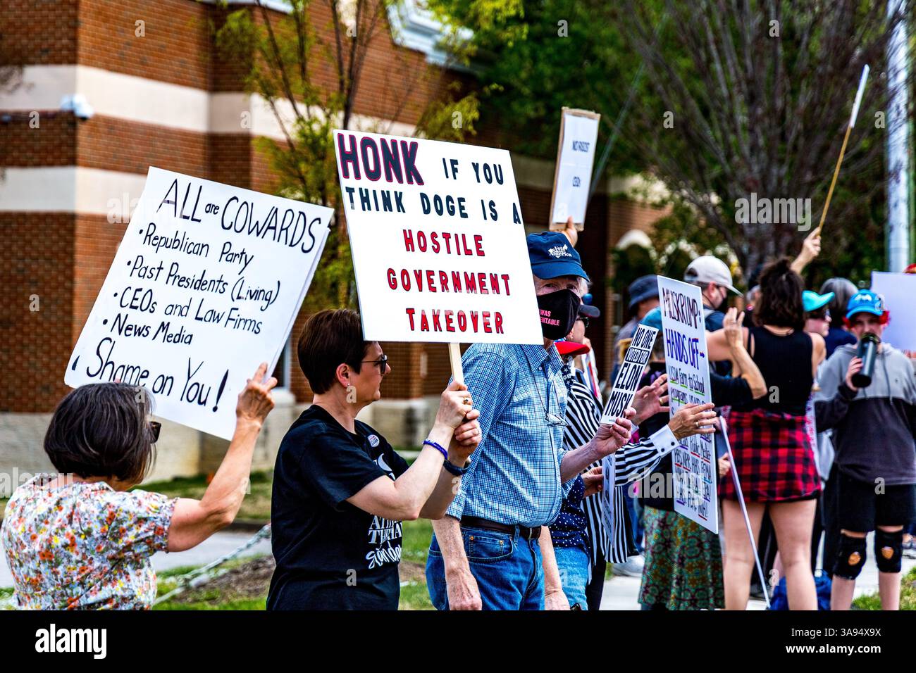 Richmond, Virginia, USA. 29th Mar, 2025. Protesters hold signs and ...