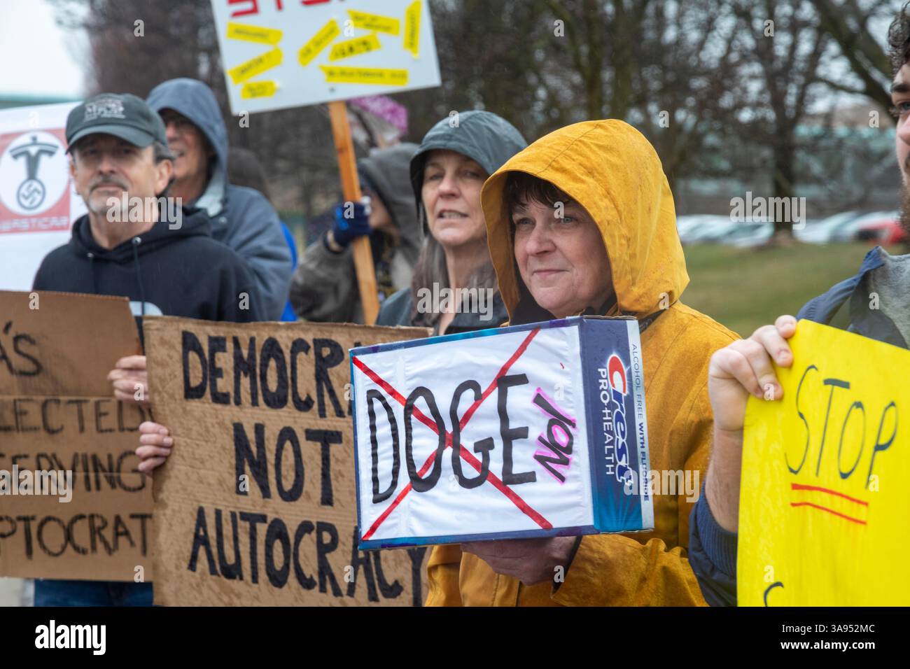 Troy, Michigan, USA. 29th Mar, 2025. People gathered in the rain ...