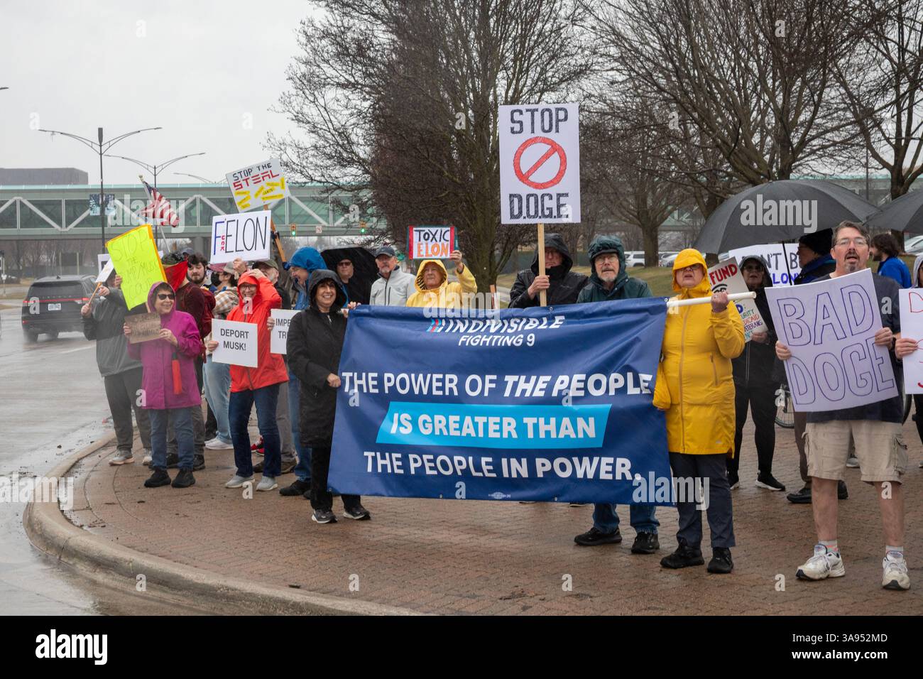 Troy, Michigan, USA. 29th Mar, 2025. People gathered in the rain ...