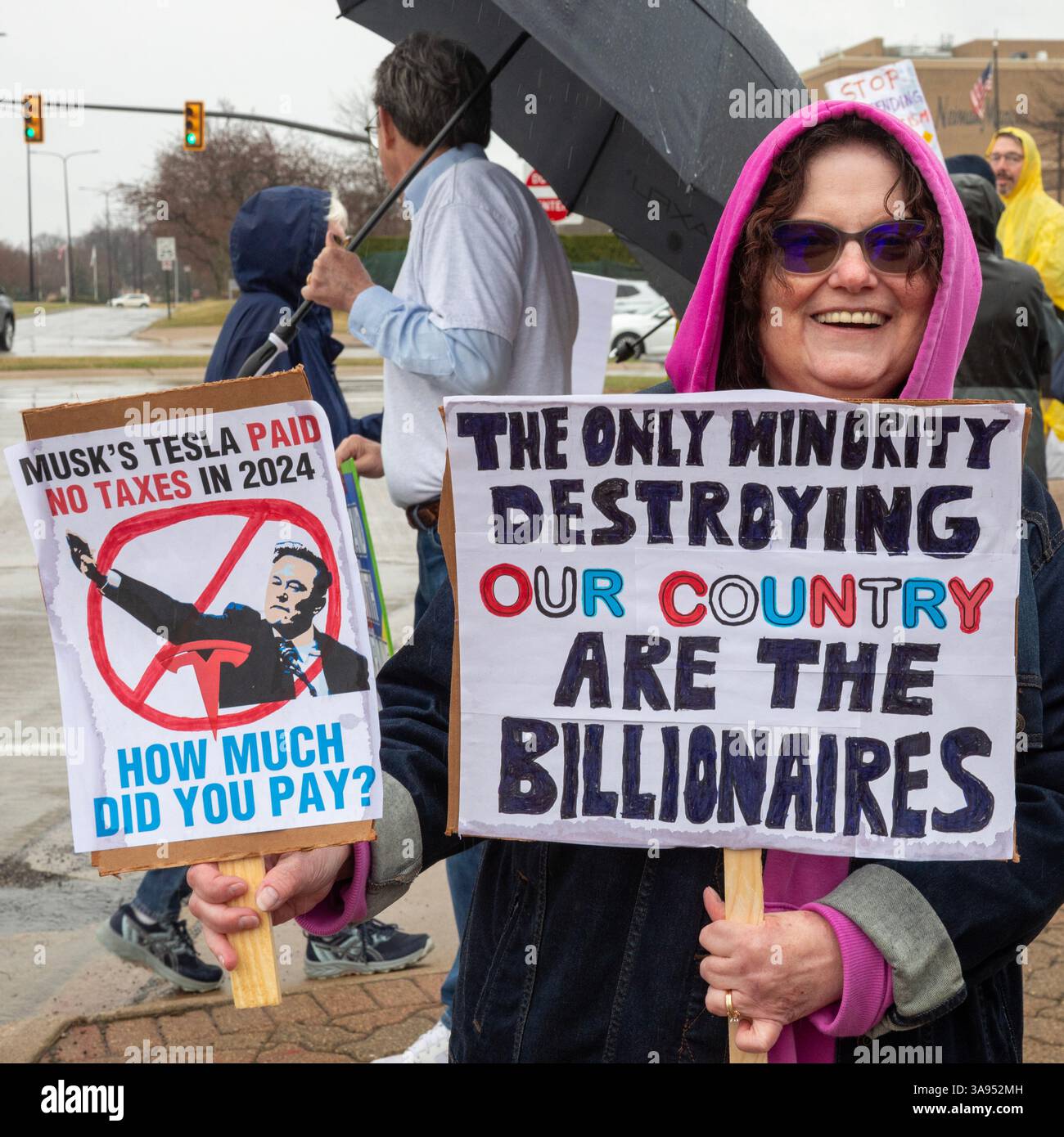 Troy, Michigan, USA. 29th Mar, 2025. People gathered in the rain ...
