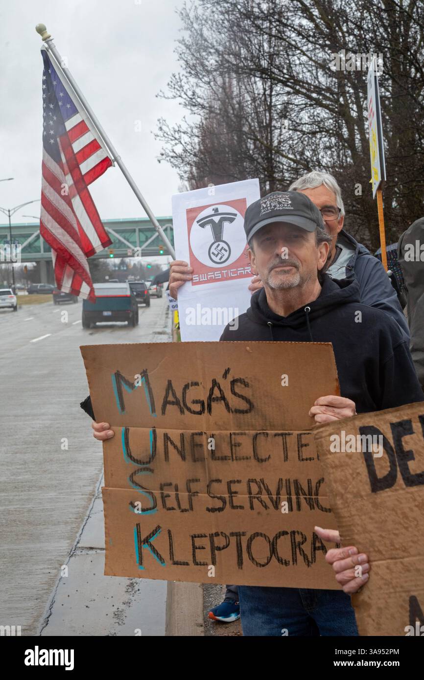 Troy, Michigan, USA. 29th Mar, 2025. People gathered in the rain ...