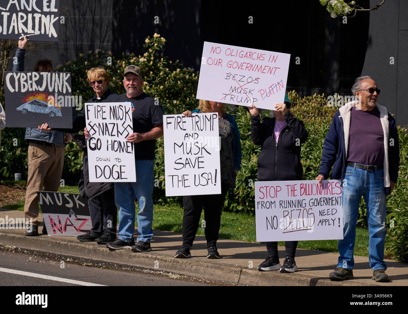 Pro-democracy demonstrators call for a boycott of Tesla in Eugene ...