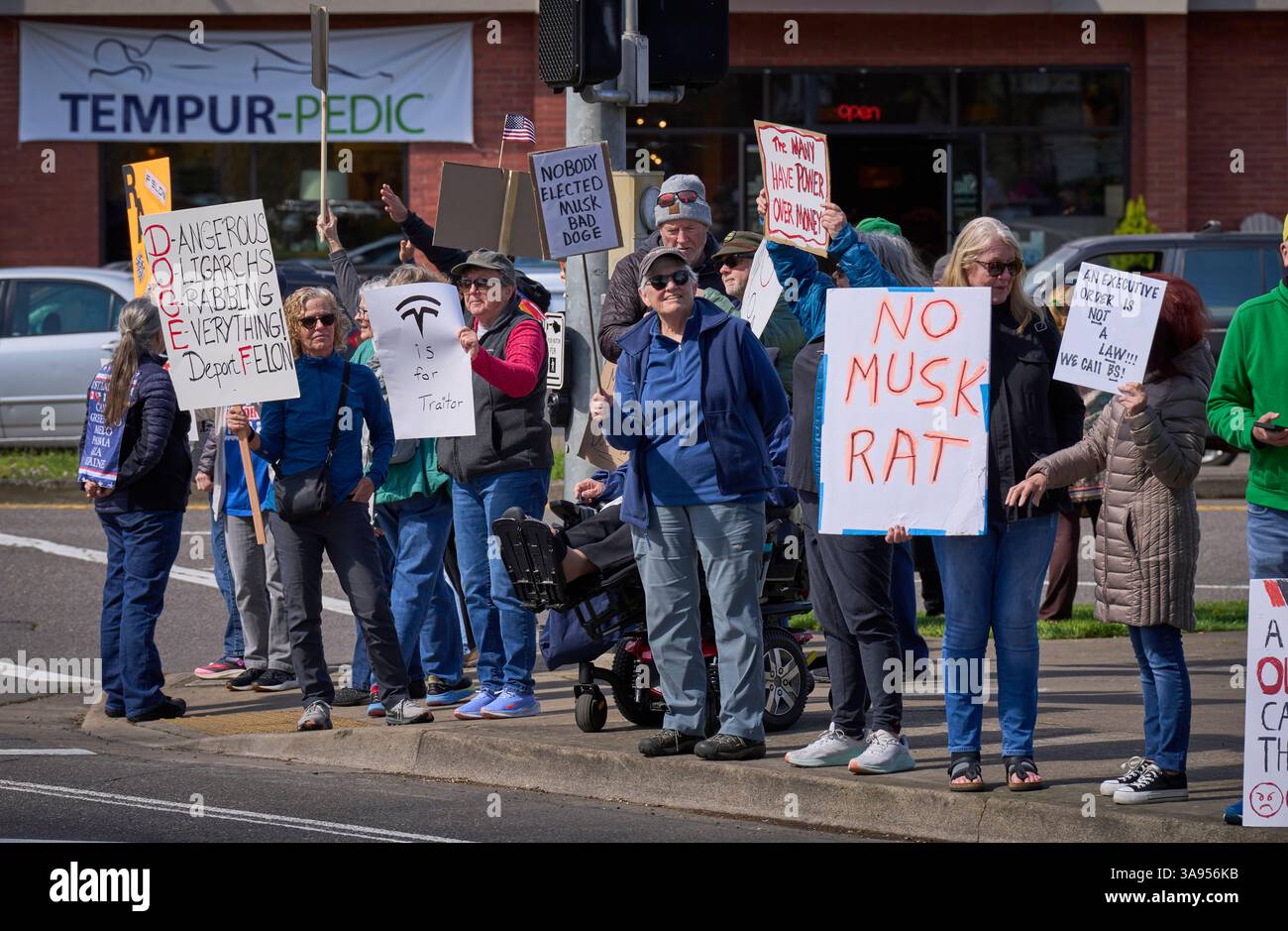 Pro-democracy demonstrators call for a boycott of Tesla in Eugene ...