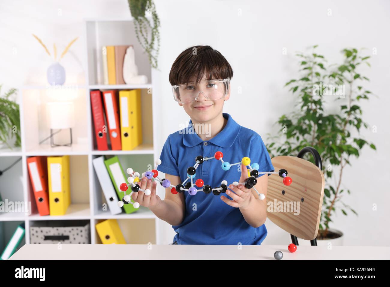 Boy with DNA structure model at desk indoors Stock Photo - Alamy