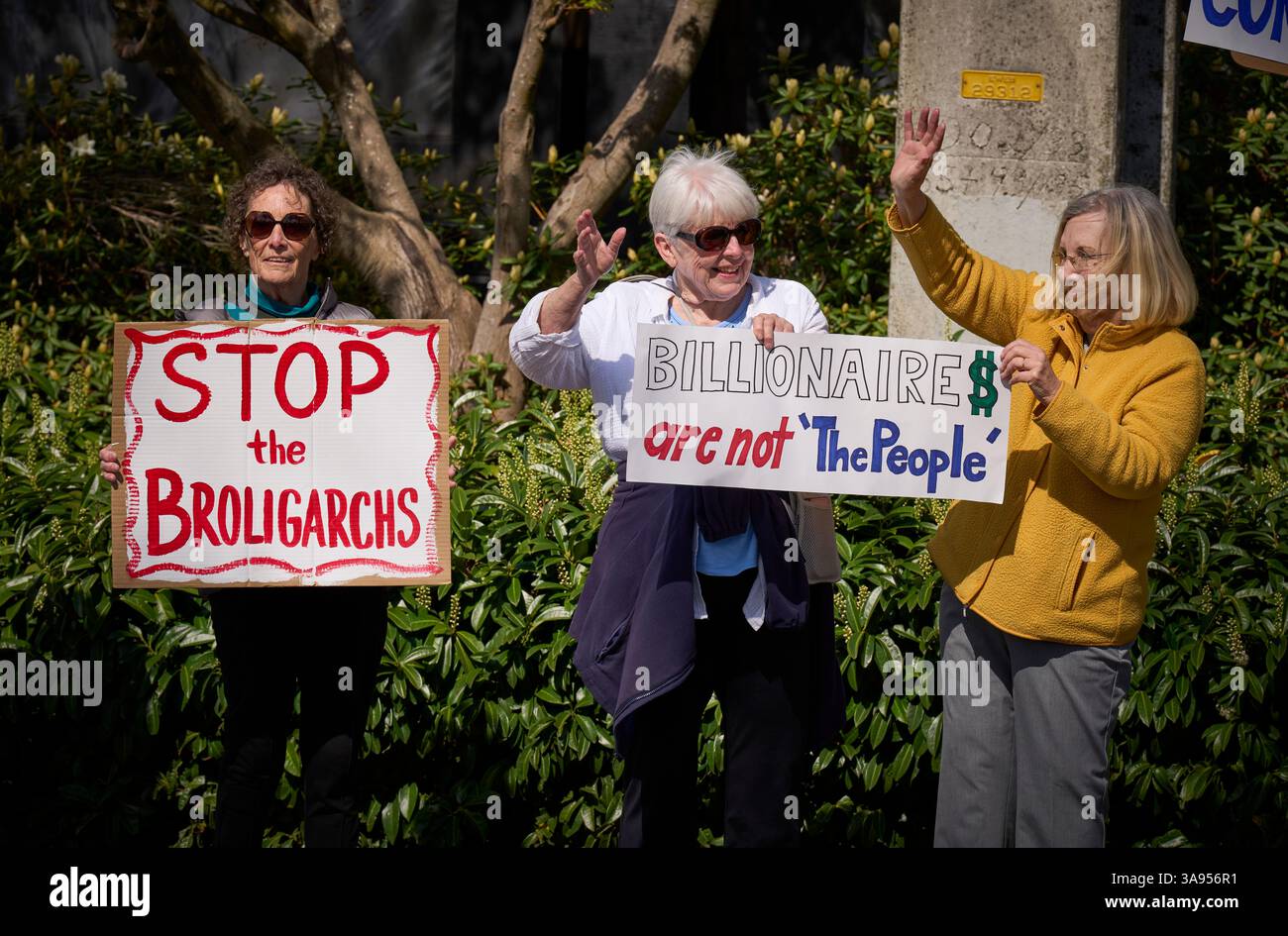 Pro-democracy demonstrators call for a boycott of Tesla in Eugene ...
