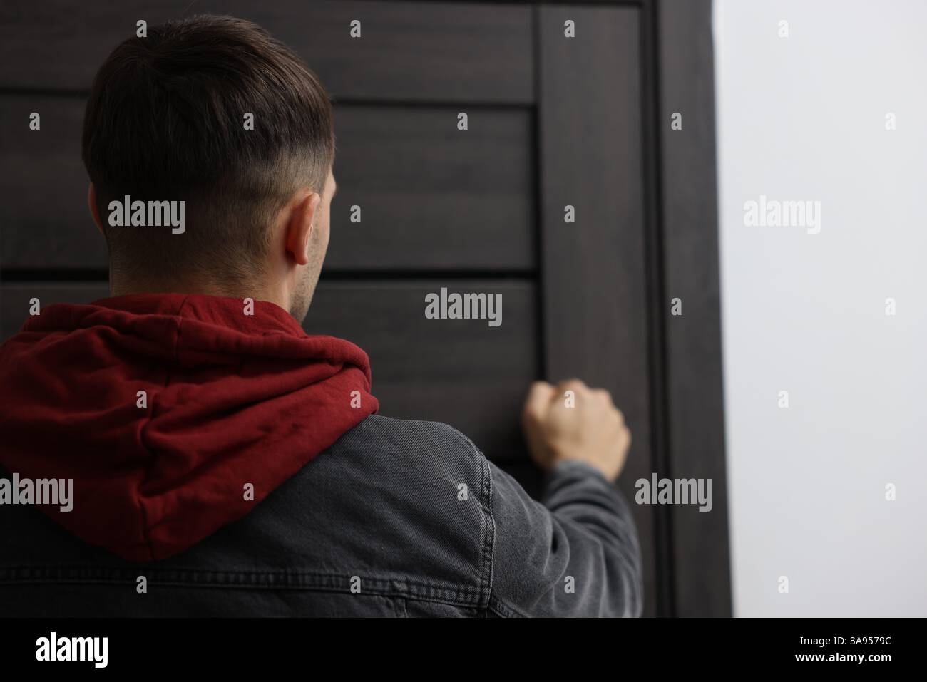 Man knocking on door of his friends apartment Stock Photo - Alamy