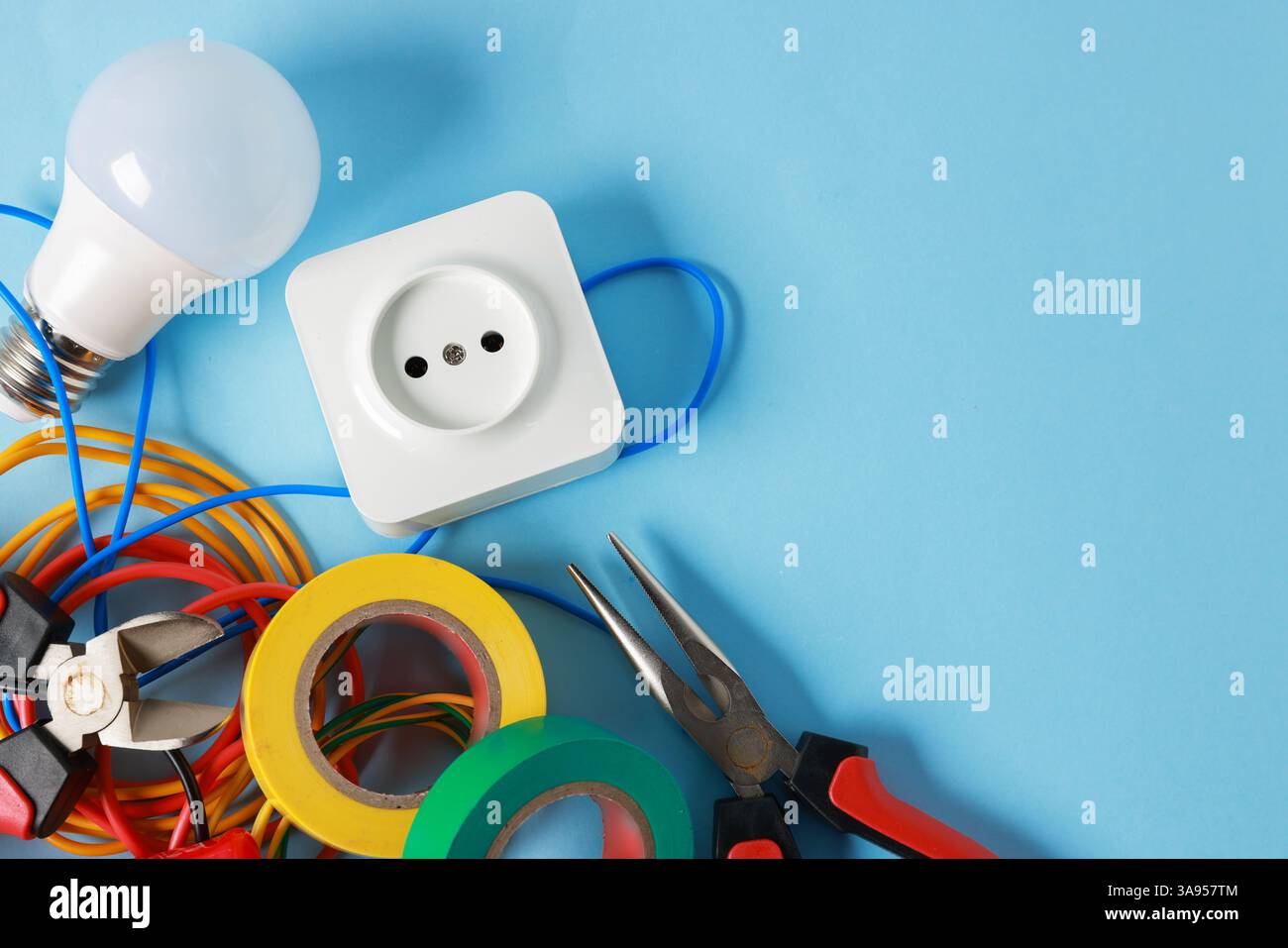 Different electrical tools on light blue background, flat lay. Space ...