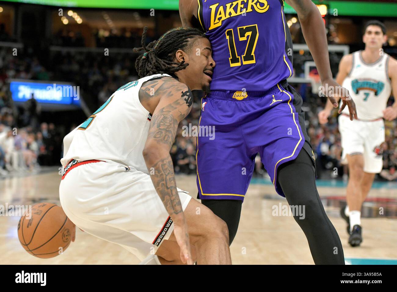 Memphis Grizzlies guard Ja Morant, left, collides with Los Angeles ...