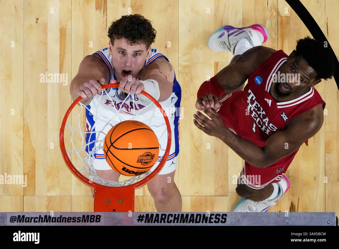 Florida center Micah Handlogten, left, dunks next to Texas Tech guard ...