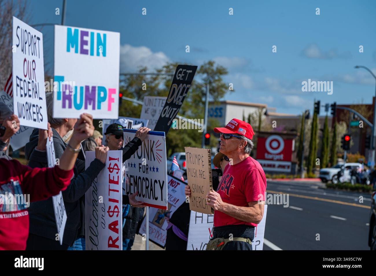 A Trump/Musk supporter engages with counter activists at a protest at a ...