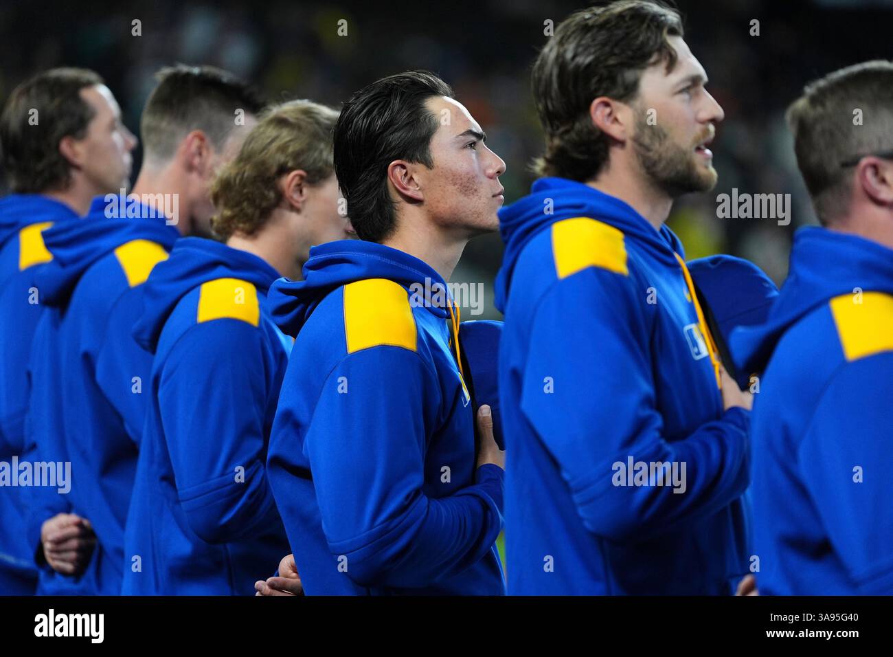 Seattle Mariners starting pitcher Bryan Woo stands during the national ...