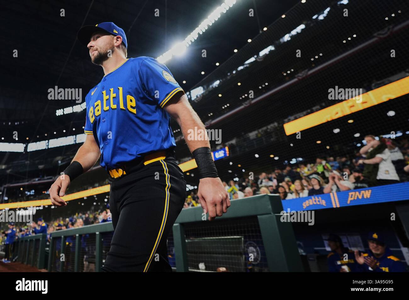 Seattle Mariners catcher Cal Raleigh walks out to the field to receive ...