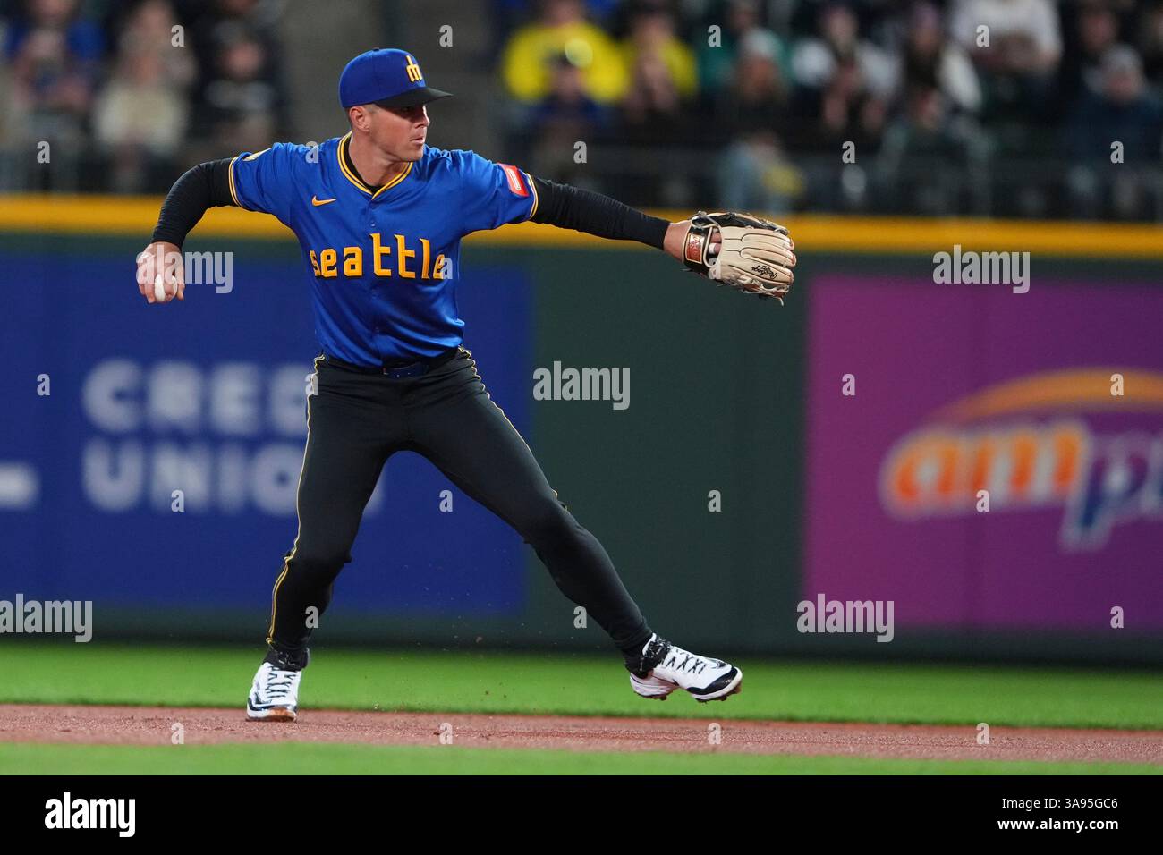 Seattle Mariners second baseman Dylan Moore makes a throw to first base ...