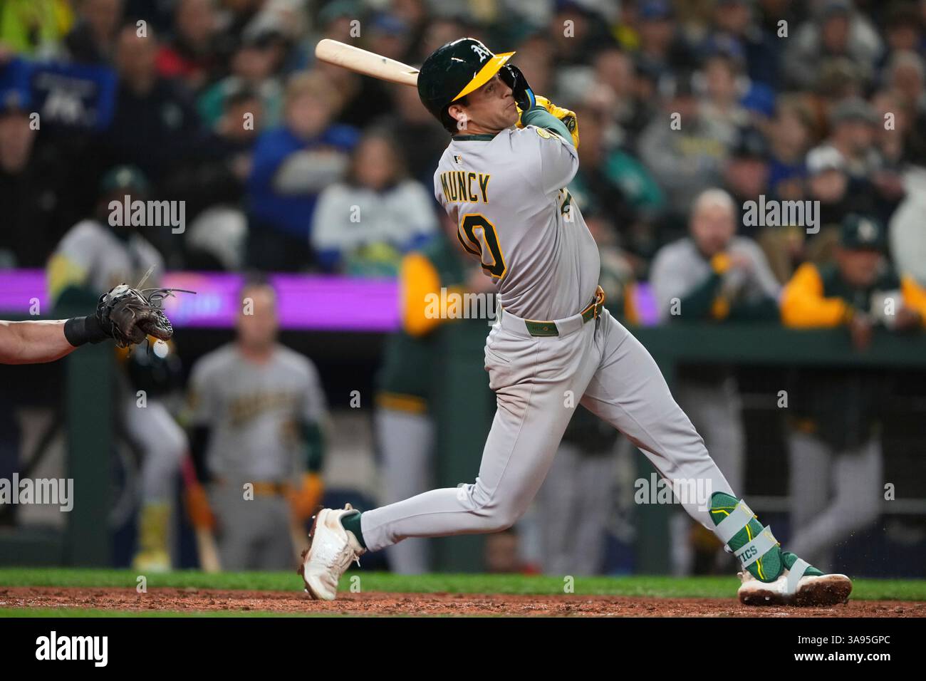 Athletics' Max Muncy follows through against the Seattle Mariners ...