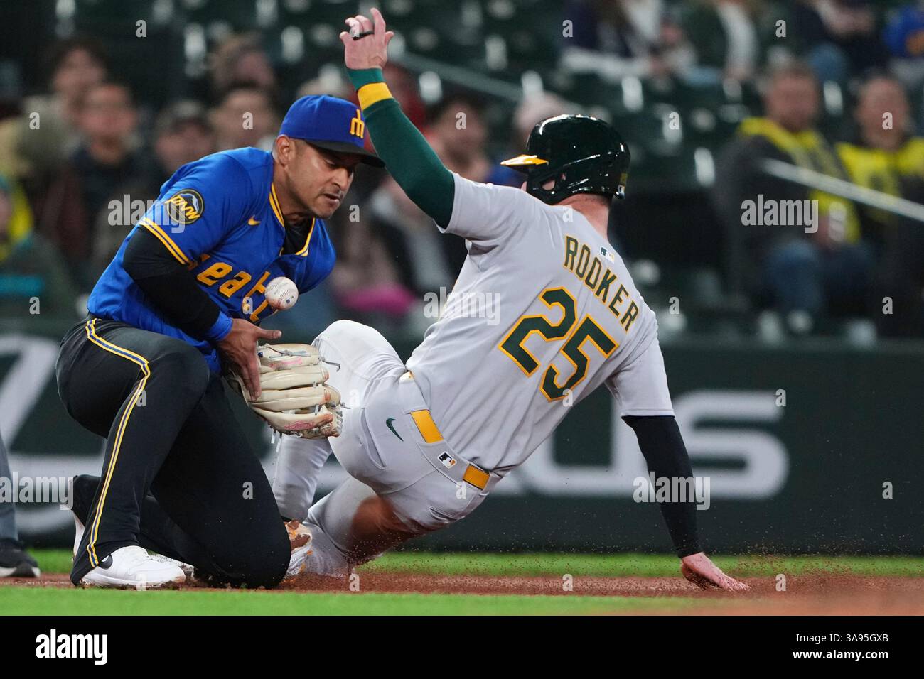 Seattle Mariners third baseman Donovan Solano tries to catch a low throw as Athletics' Brent ...