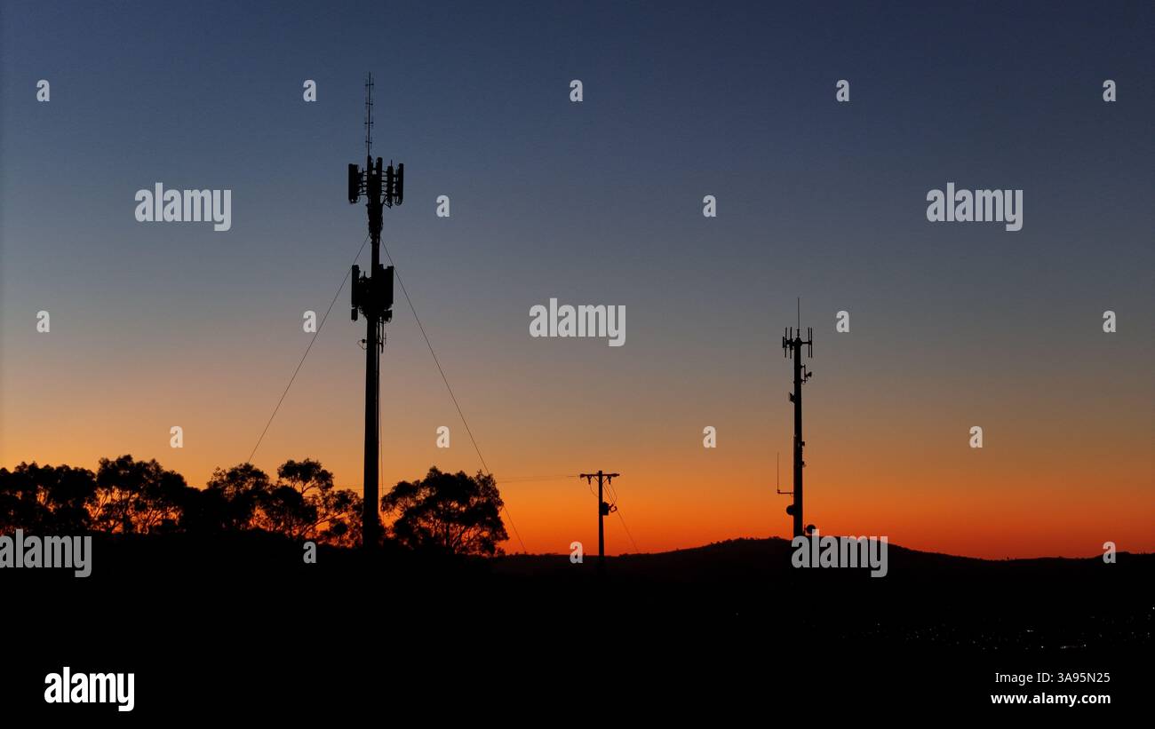 Silhouette of mobile phone towers on a hill in regional Victoria Stock ...