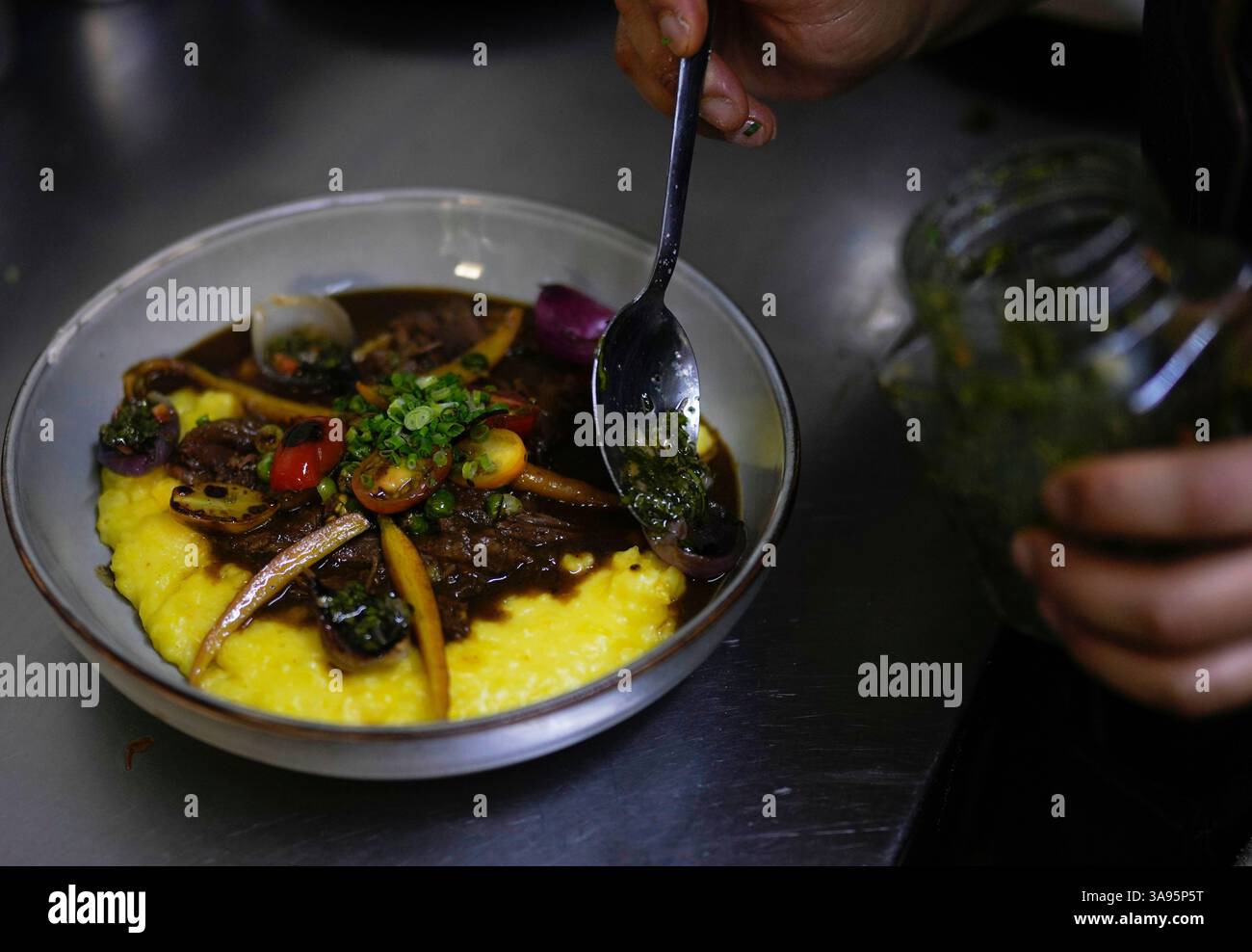 Chef Carolina Chuquimia prepares a dish of beef steak with yucca at La ...